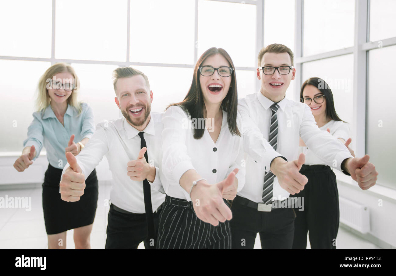 happy business team showing their thumbs up Stock Photo - Alamy