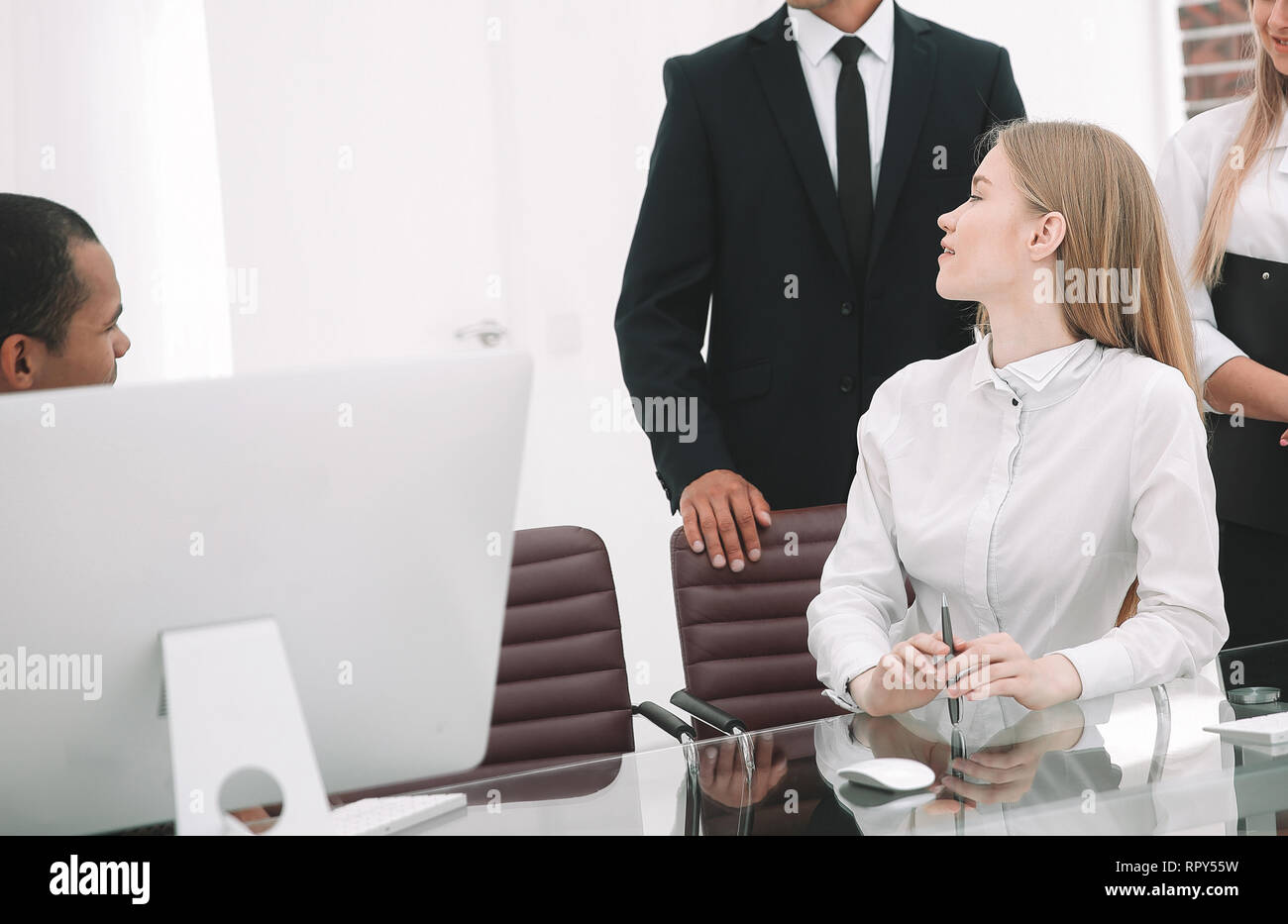 closeup.the employees are talking in a modern office Stock Photo - Alamy