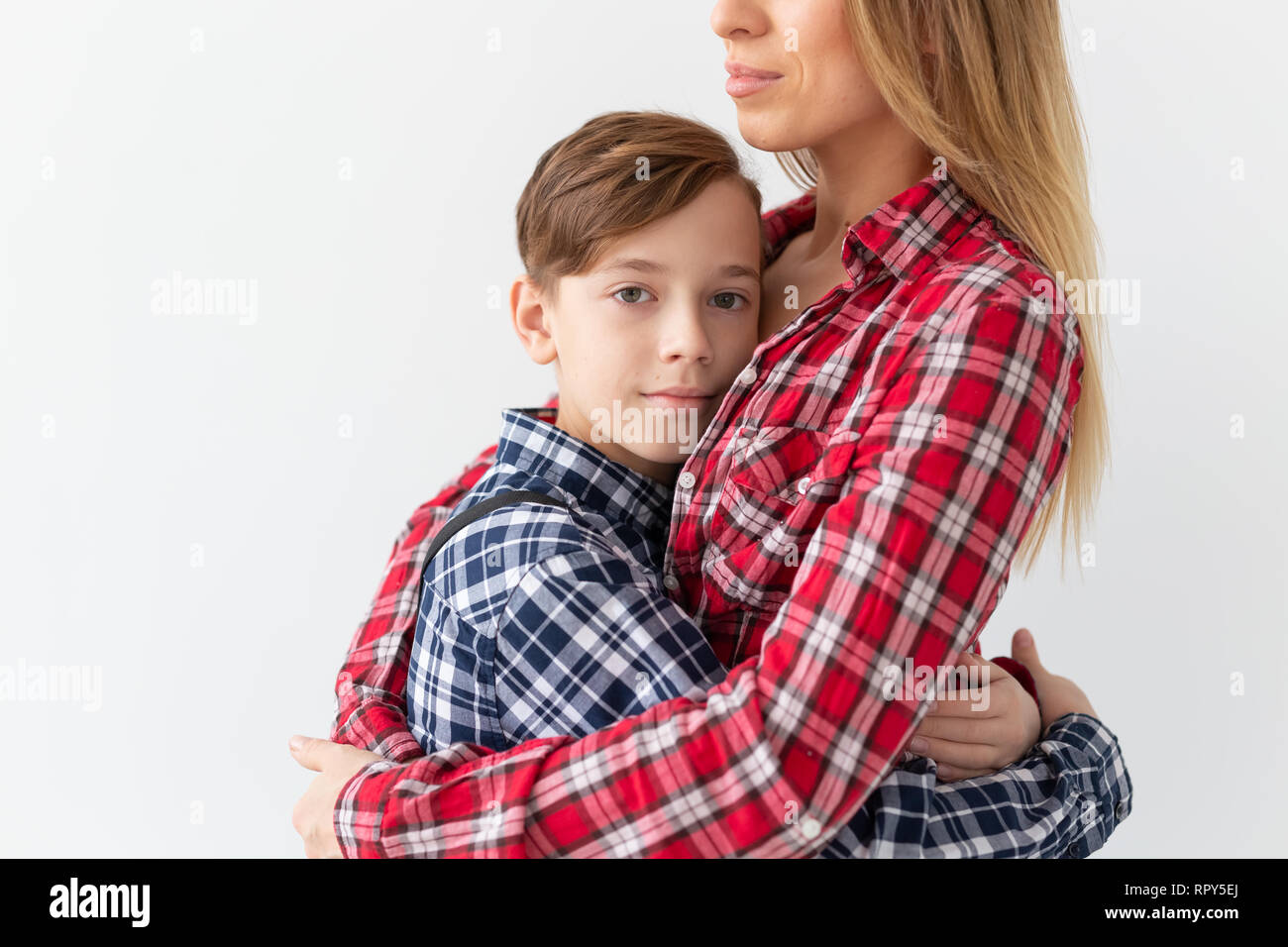 Mothers day, children and family concept - teen boy hugging his mom on ...