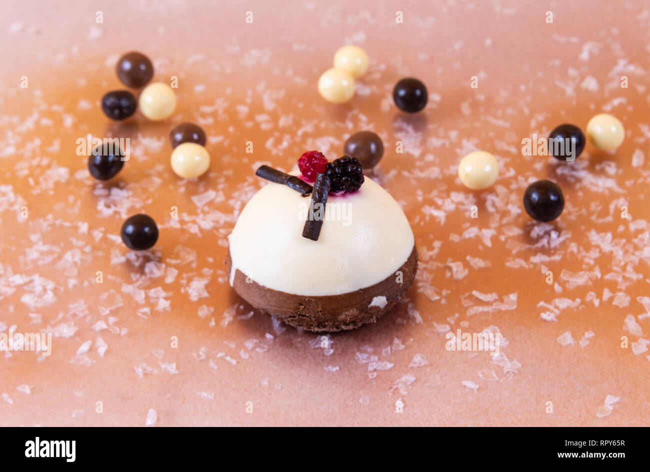 light and sumptuous pastry on a decorated support and with a colored ...