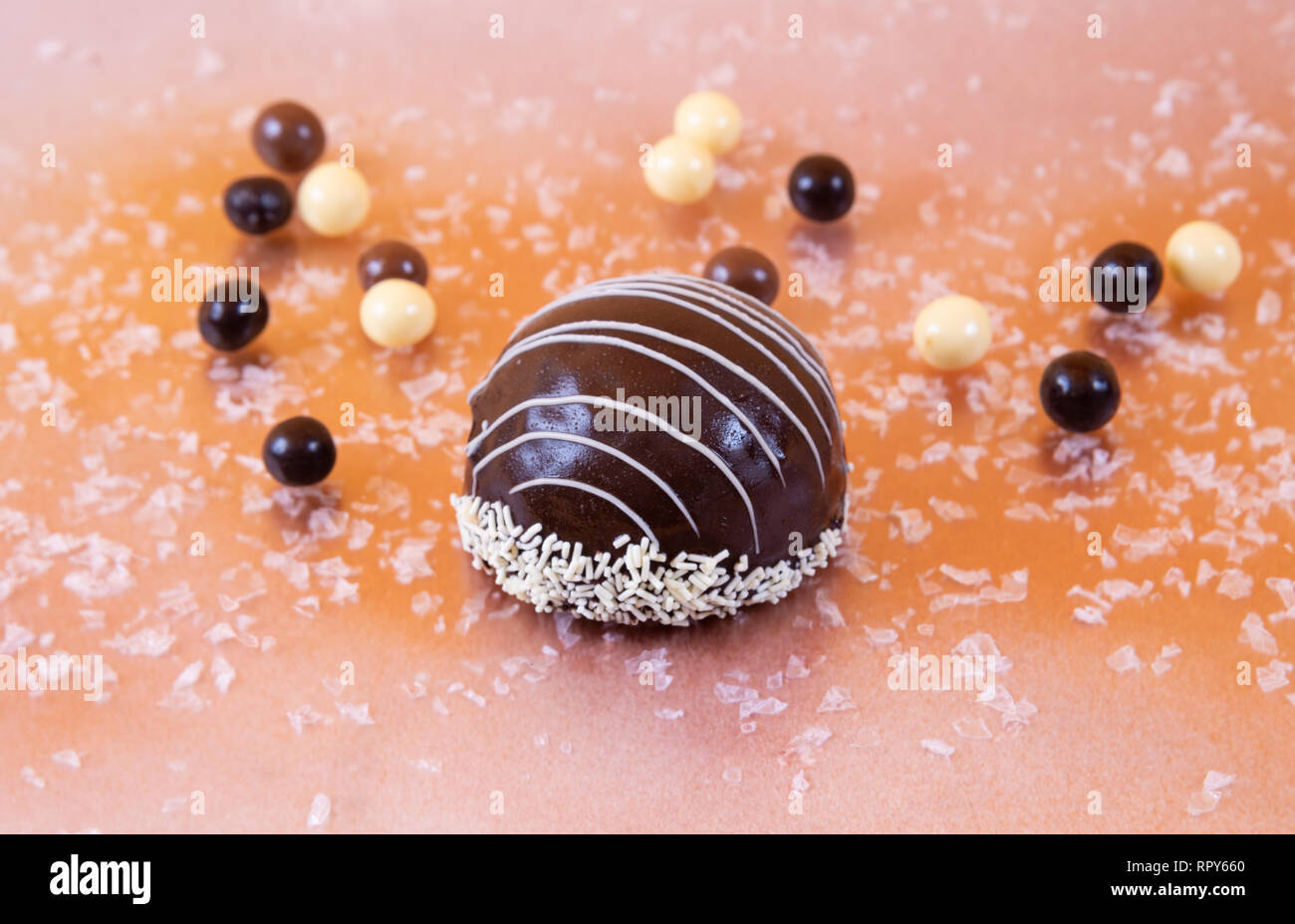 light and sumptuous pastry on a decorated support and with a colored ...