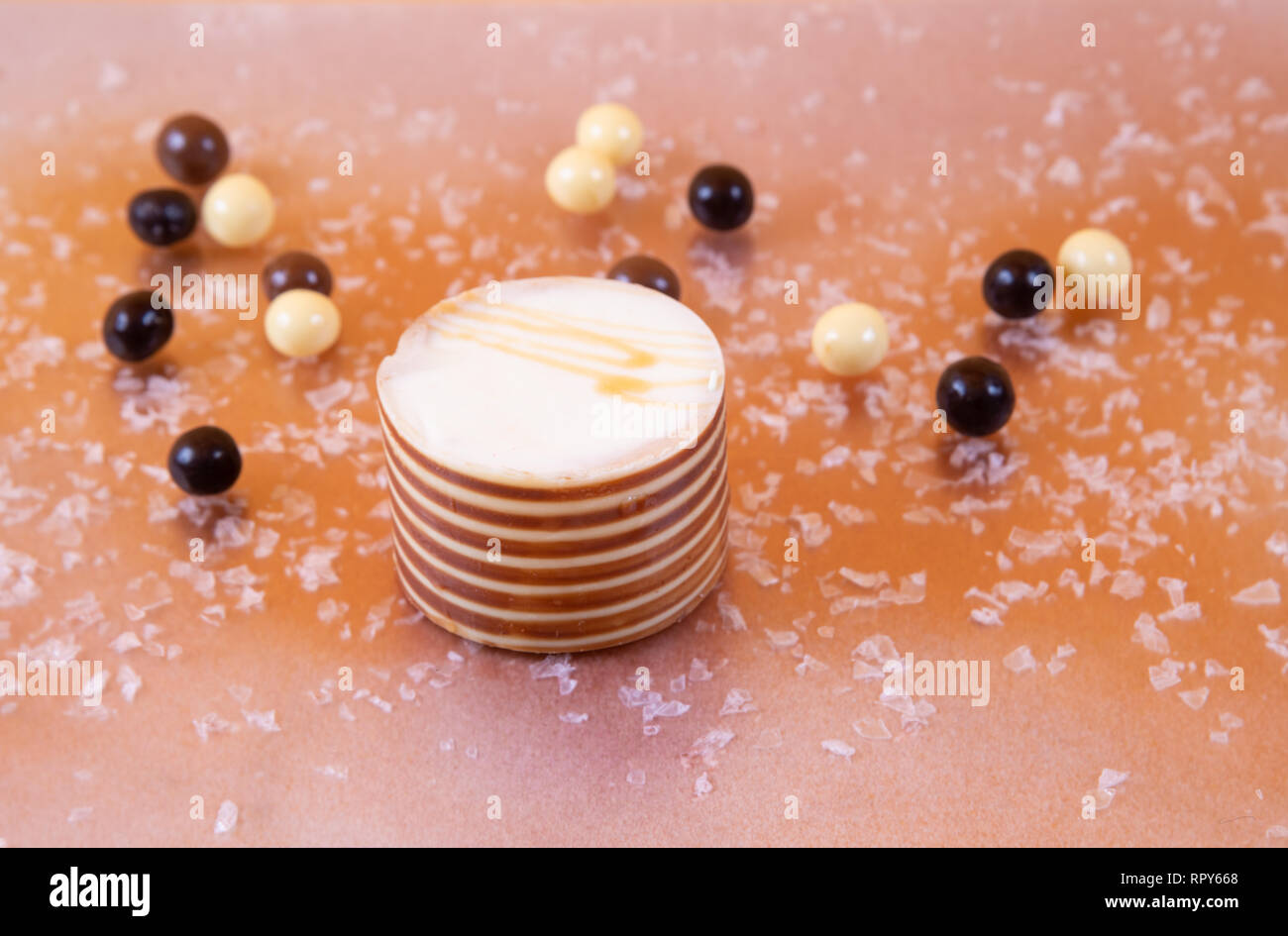 light and sumptuous pastry on a decorated support and with a colored ...