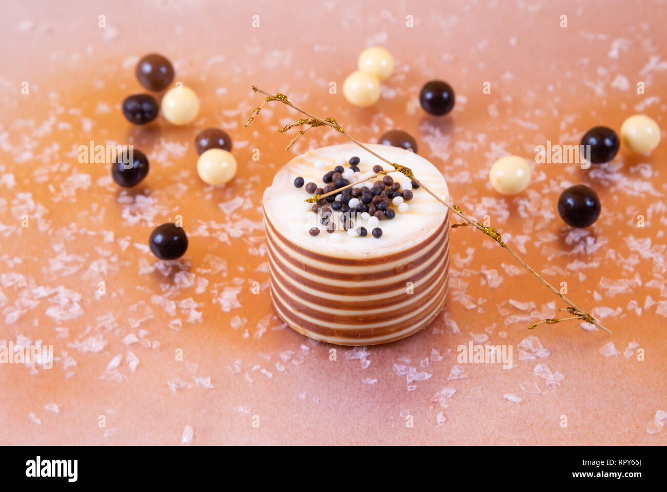 light and sumptuous pastry on a decorated support and with a colored ...