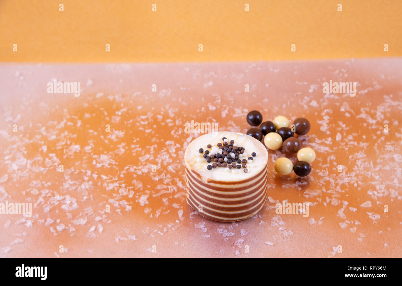 light and sumptuous pastry on a decorated support and with a colored ...