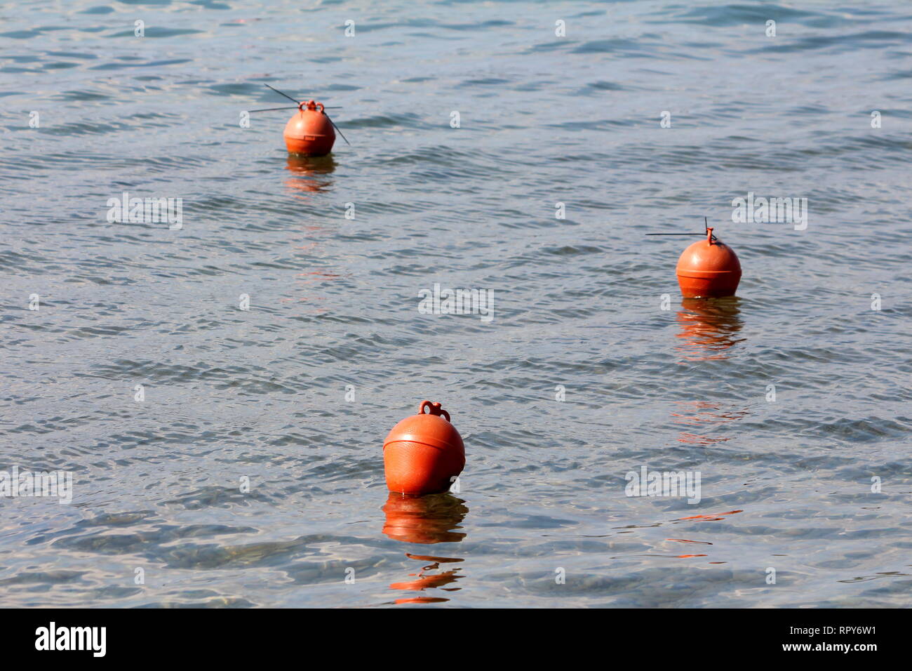 Three orange buoys floating hi-res stock photography and images - Alamy