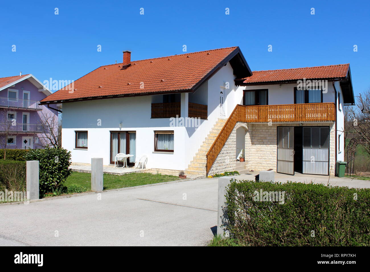White suburban family house with with outdoor stone tiles steps and ...
