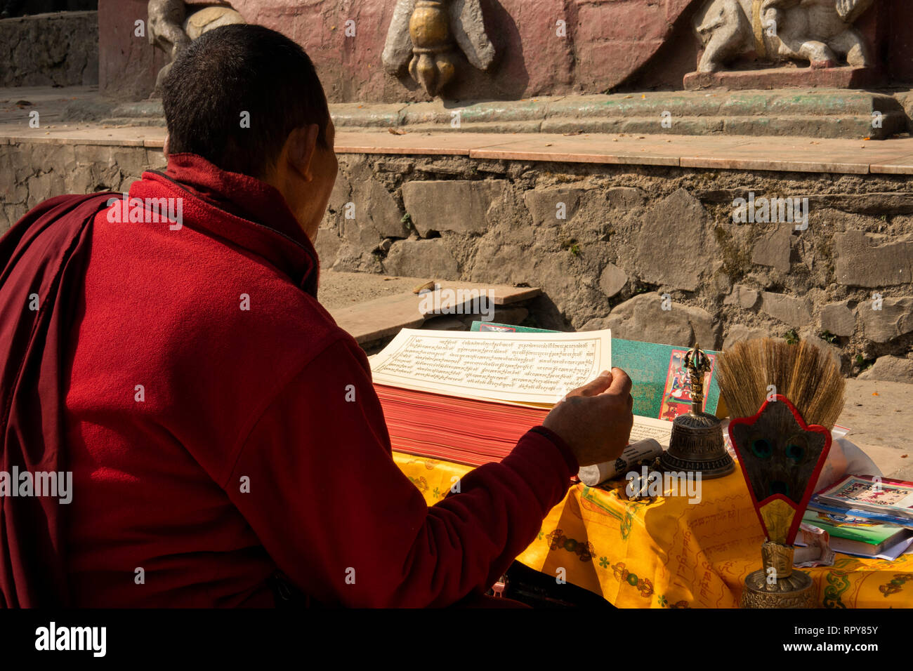 Nepal, Kathmandu, Swayambhunath Temple, Buddhist monk reading religious ...