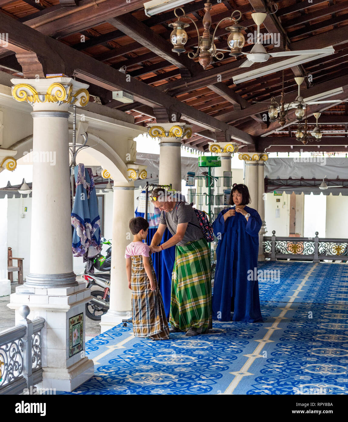 Foreign Tourists Putting on Traditional Clothing before Entering ...