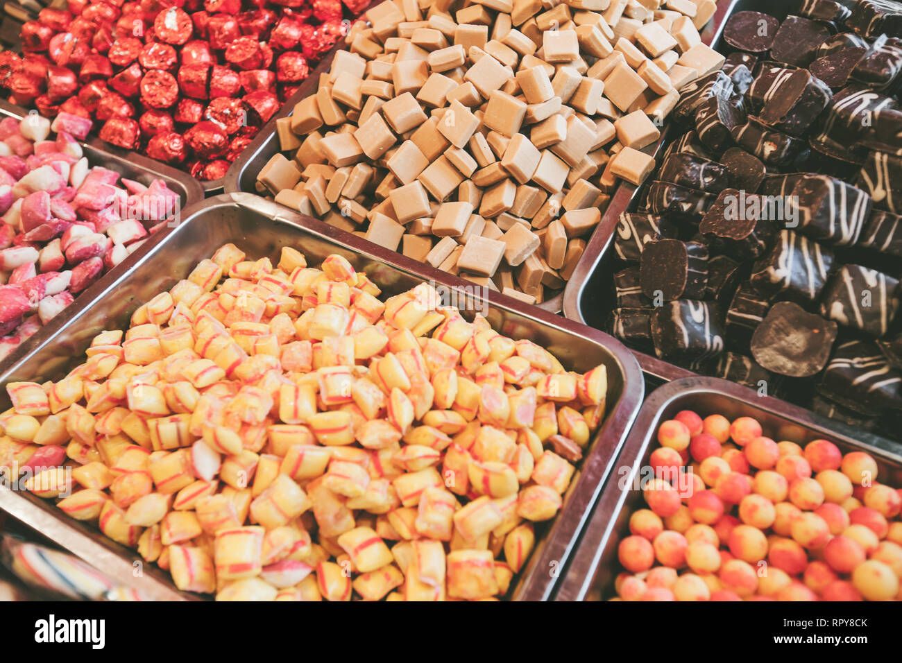 Various colorful festive sweets for sale at open candy shop on market ...