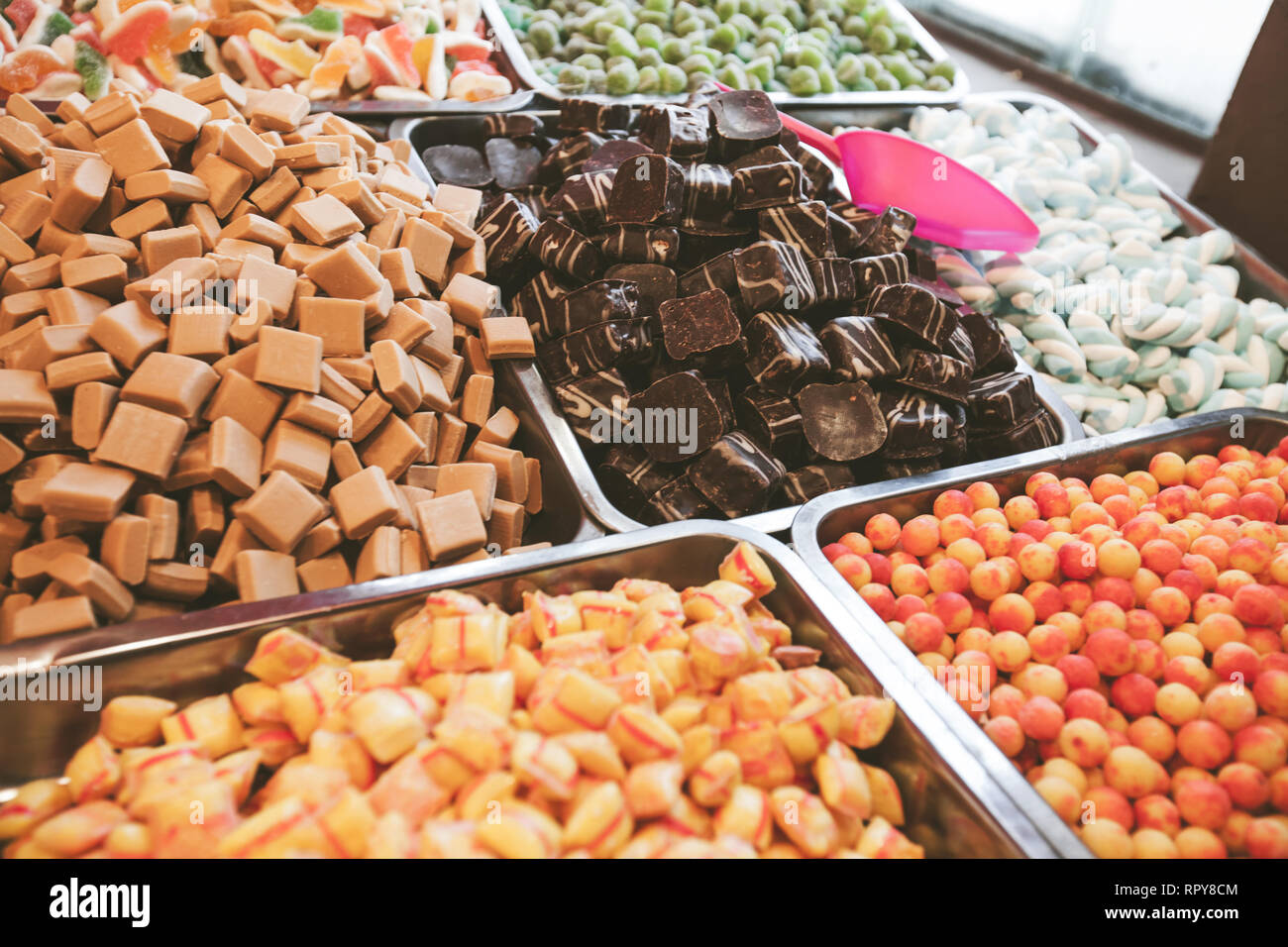 Various colorful festive sweets for sale at open candy shop on market ...
