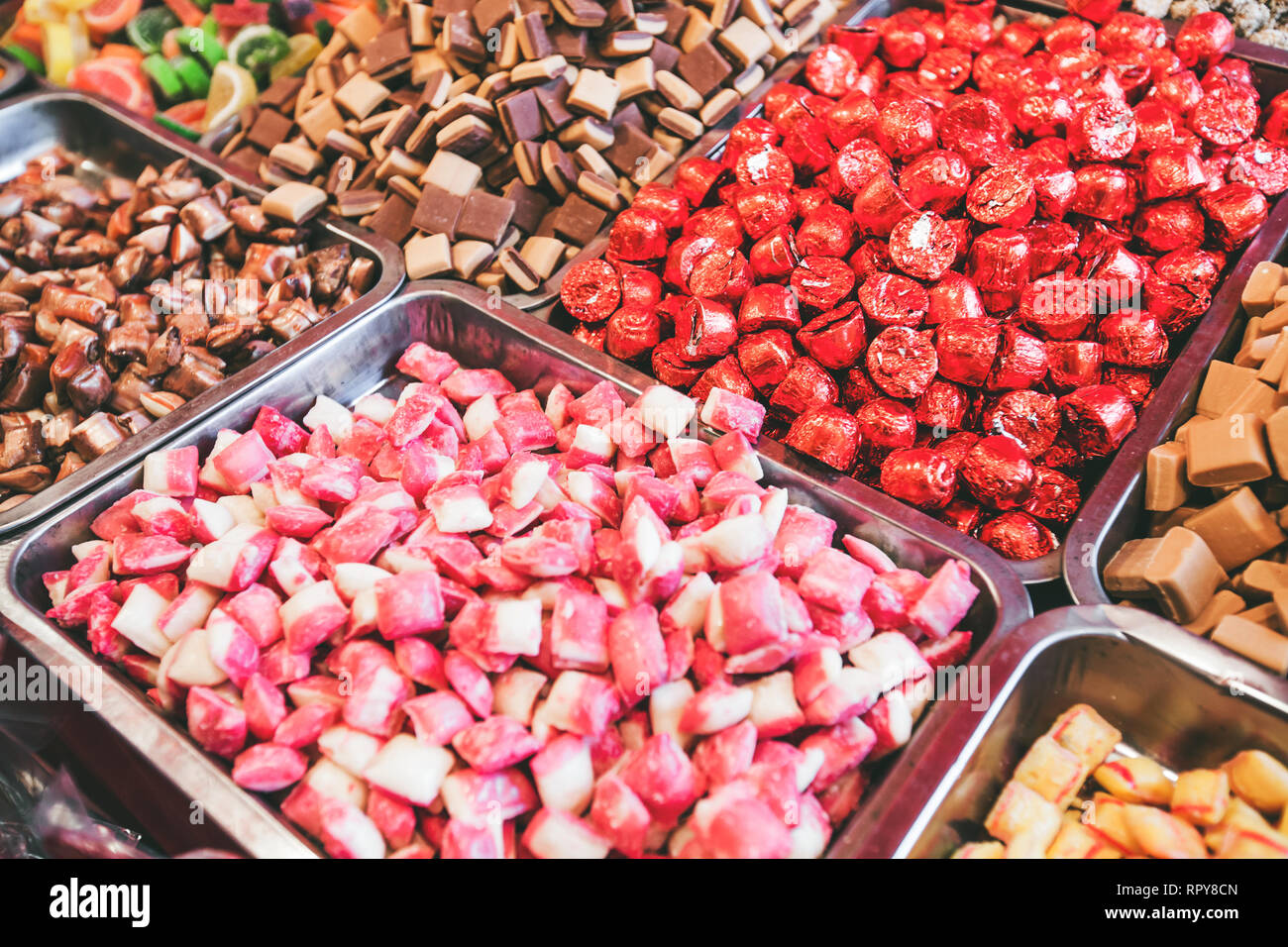 Various colorful festive sweets for sale at open candy shop on market ...
