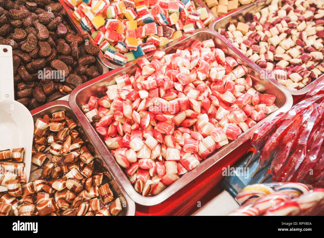 Various colorful festive sweets for sale at open candy shop on market ...