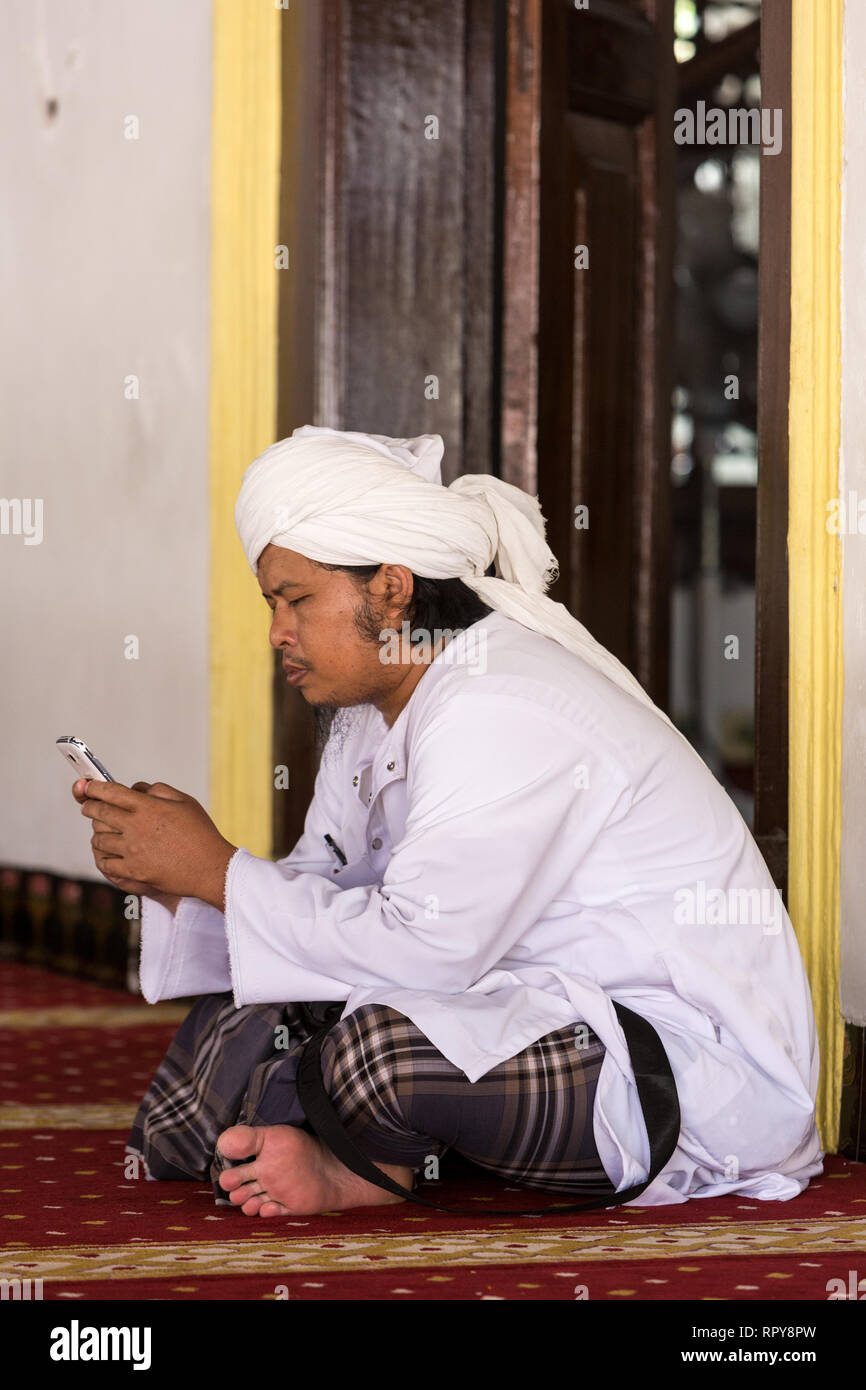 Malaysian Man Checking his Cell Phone outside the Prayer Hall of the ...