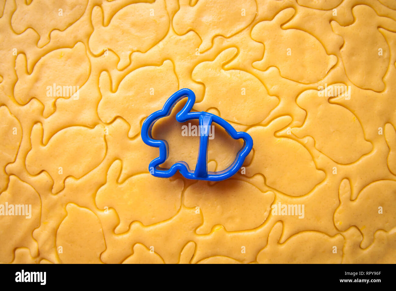 Baking Easter biscuits. Easter symbol concept. Process of cutting ...
