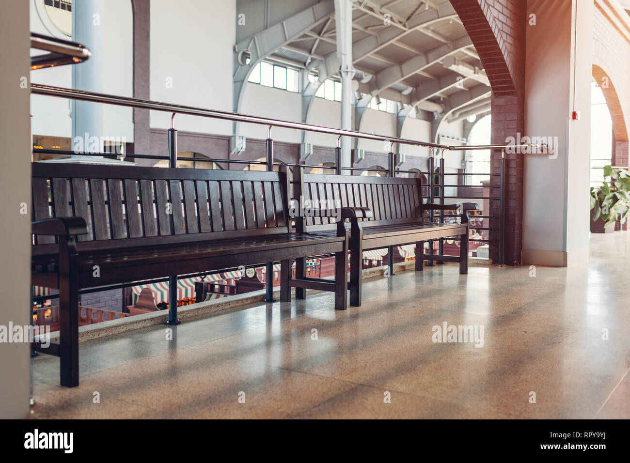 Interior of shopping center. Modern buildings. Benches to relax on ...
