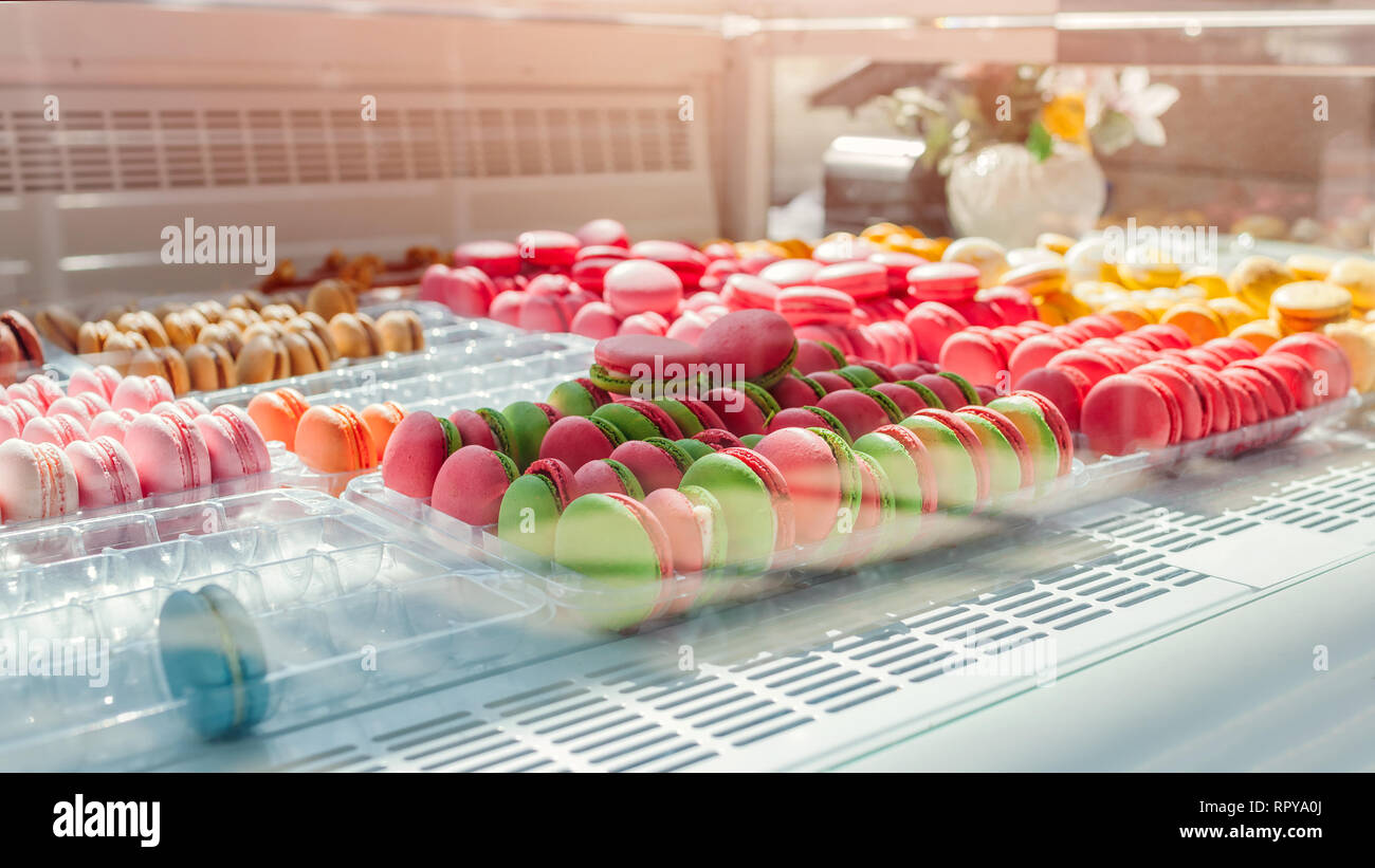 Assortment of colorful macaroons on cafe showcase. Variety of macaron ...