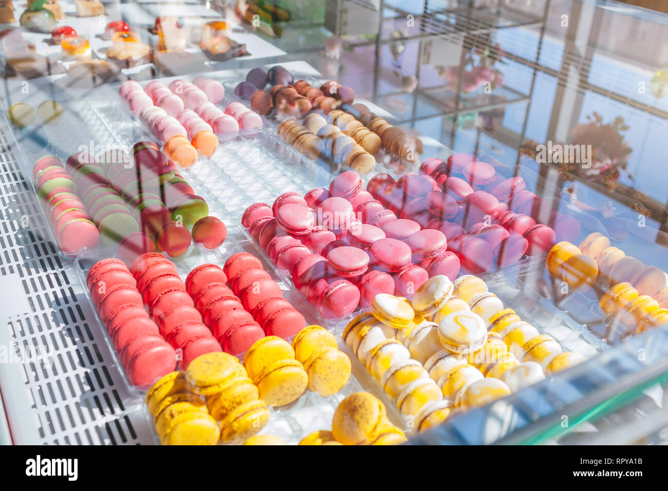 Assortment of colorful macaroons on cafe showcase. Variety of macaron ...