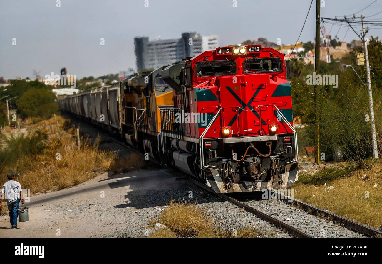 Train or Mexican railways passing through the popular colony in ...