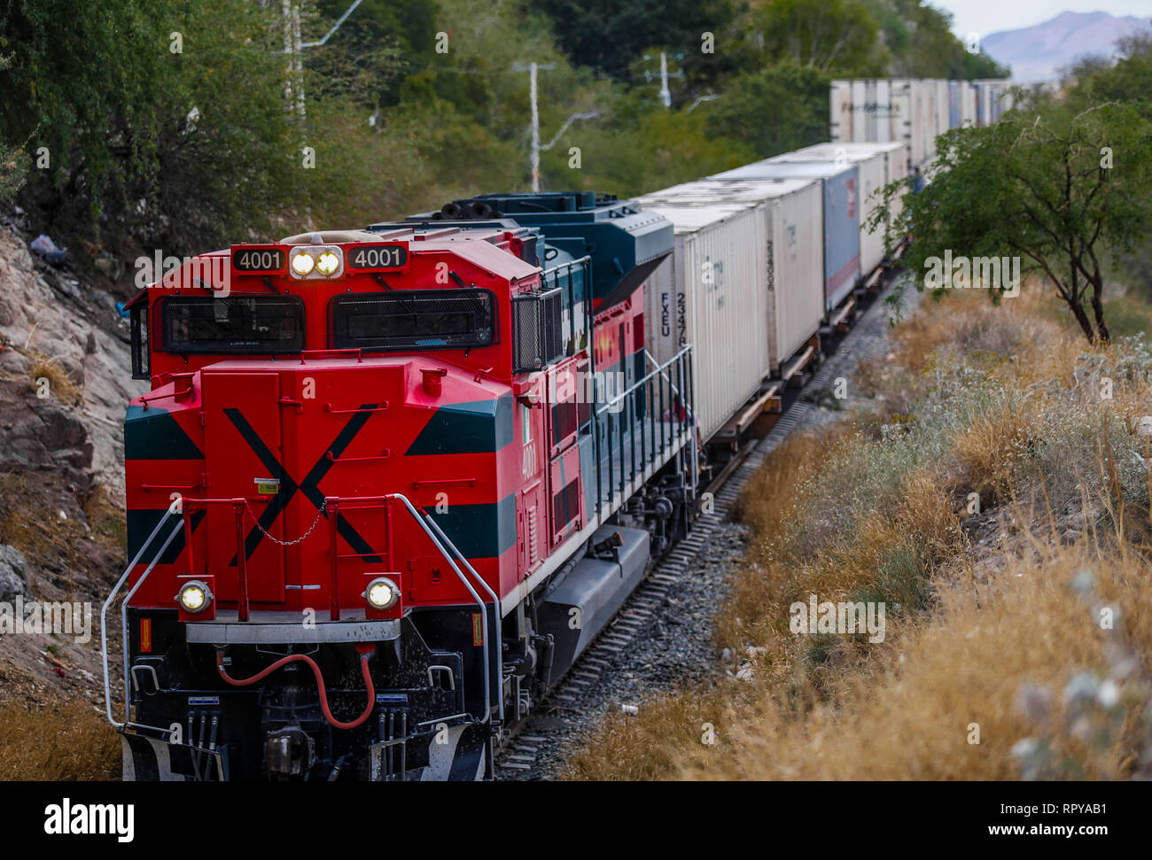 Train or Mexican railways passing through the popular colony in ...
