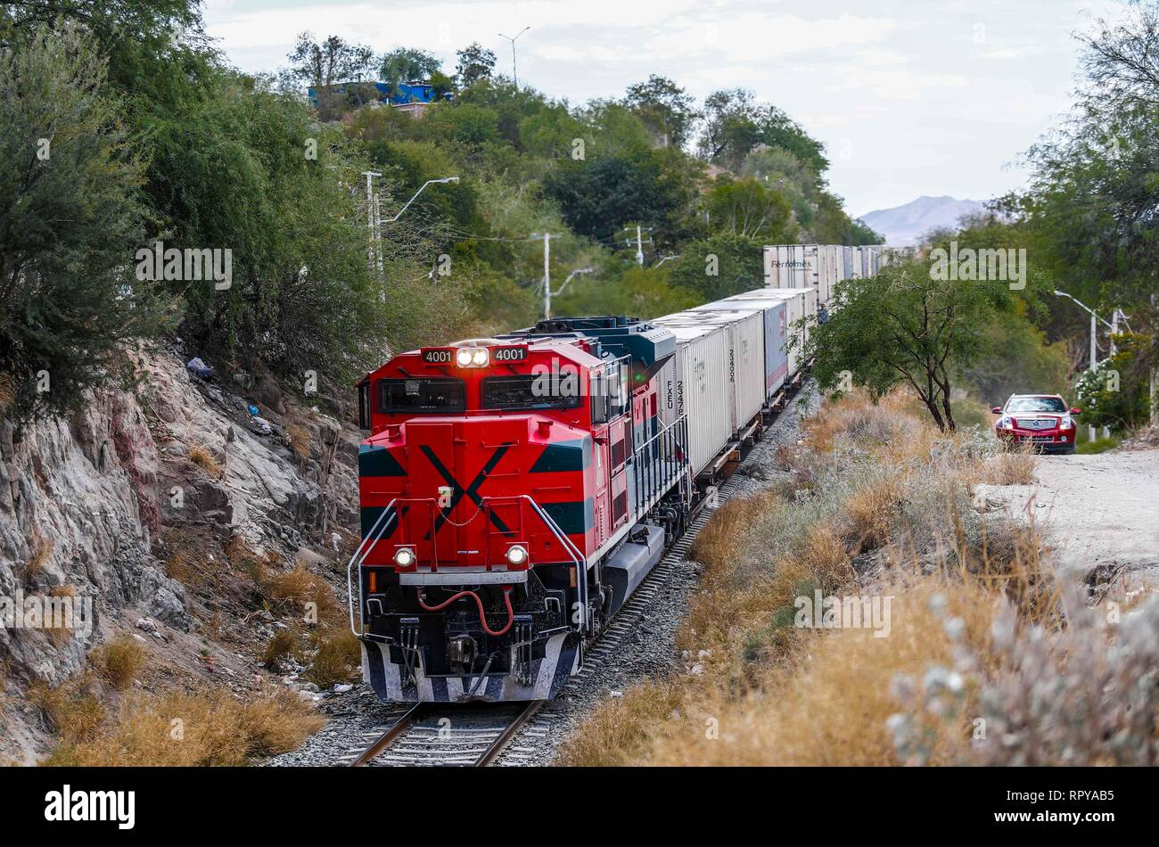 Train or Mexican railways passing through the popular colony in ...
