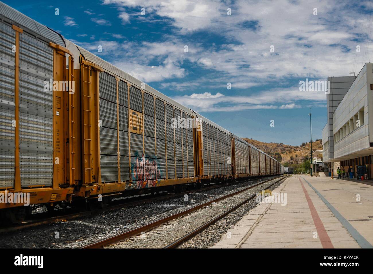 Train or Mexican railways passing through the popular colony in ...