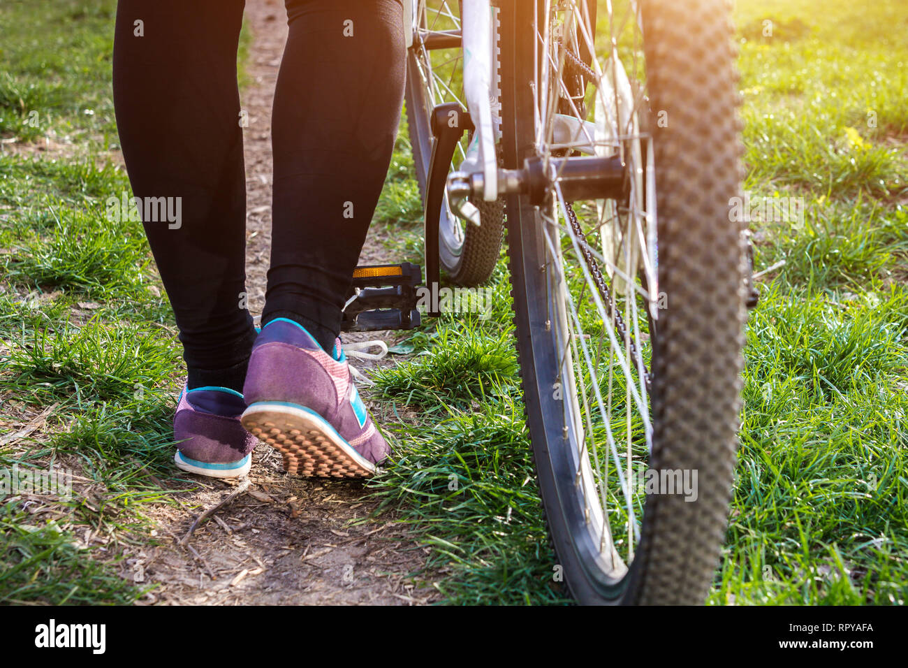 Female leg on the pedal of the bicycle in the forest Stock Photo - Alamy