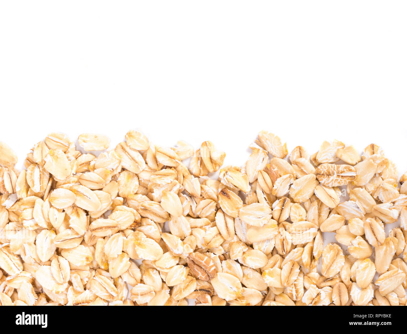 raw oatmeal on white background with copy space. Isolated one edge. Top ...
