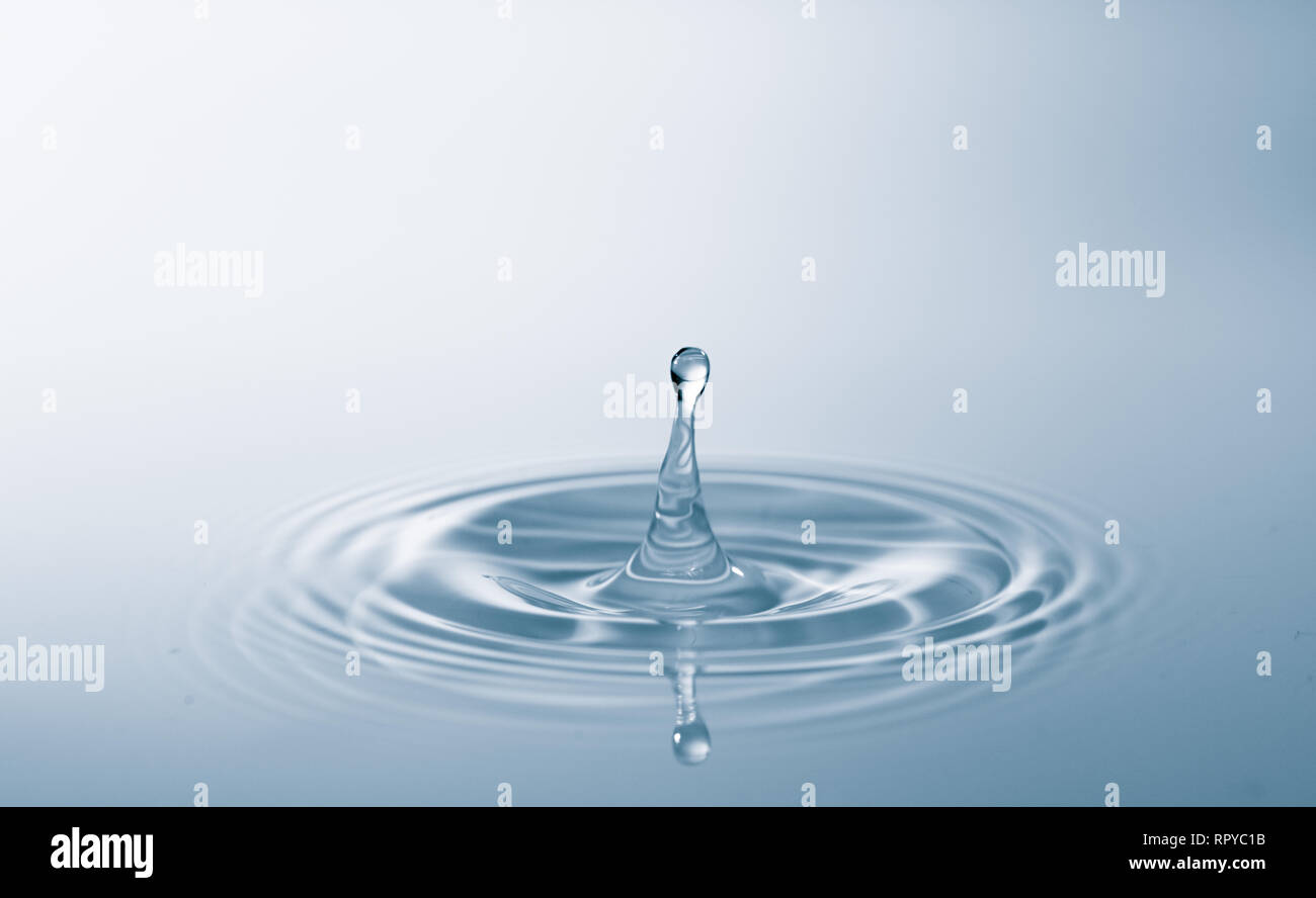 Water drop falling into water making a perfect droplet splash Stock ...