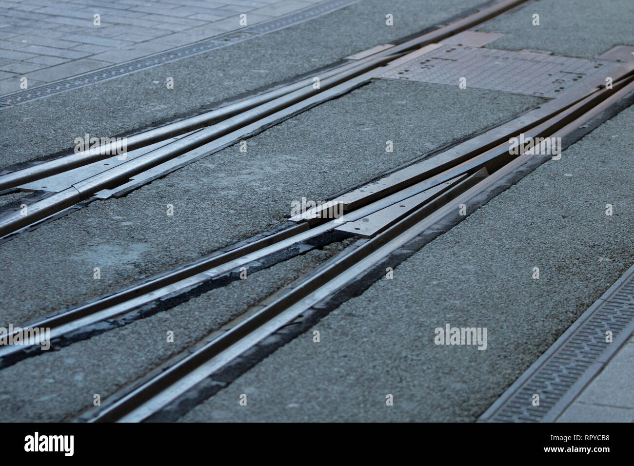 Tramway tracks intersection on pedestrian area Stock Photo - Alamy