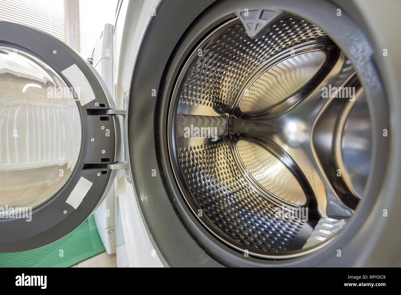 Close-up detail of modern washing machine interior with open door ...