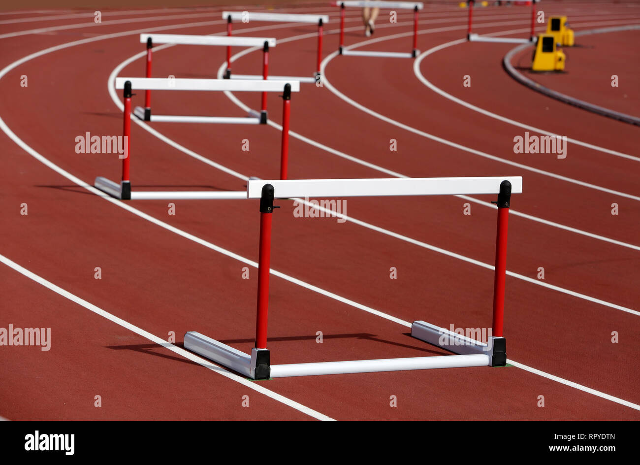 Hurdles on competition background Stock Photo - Alamy