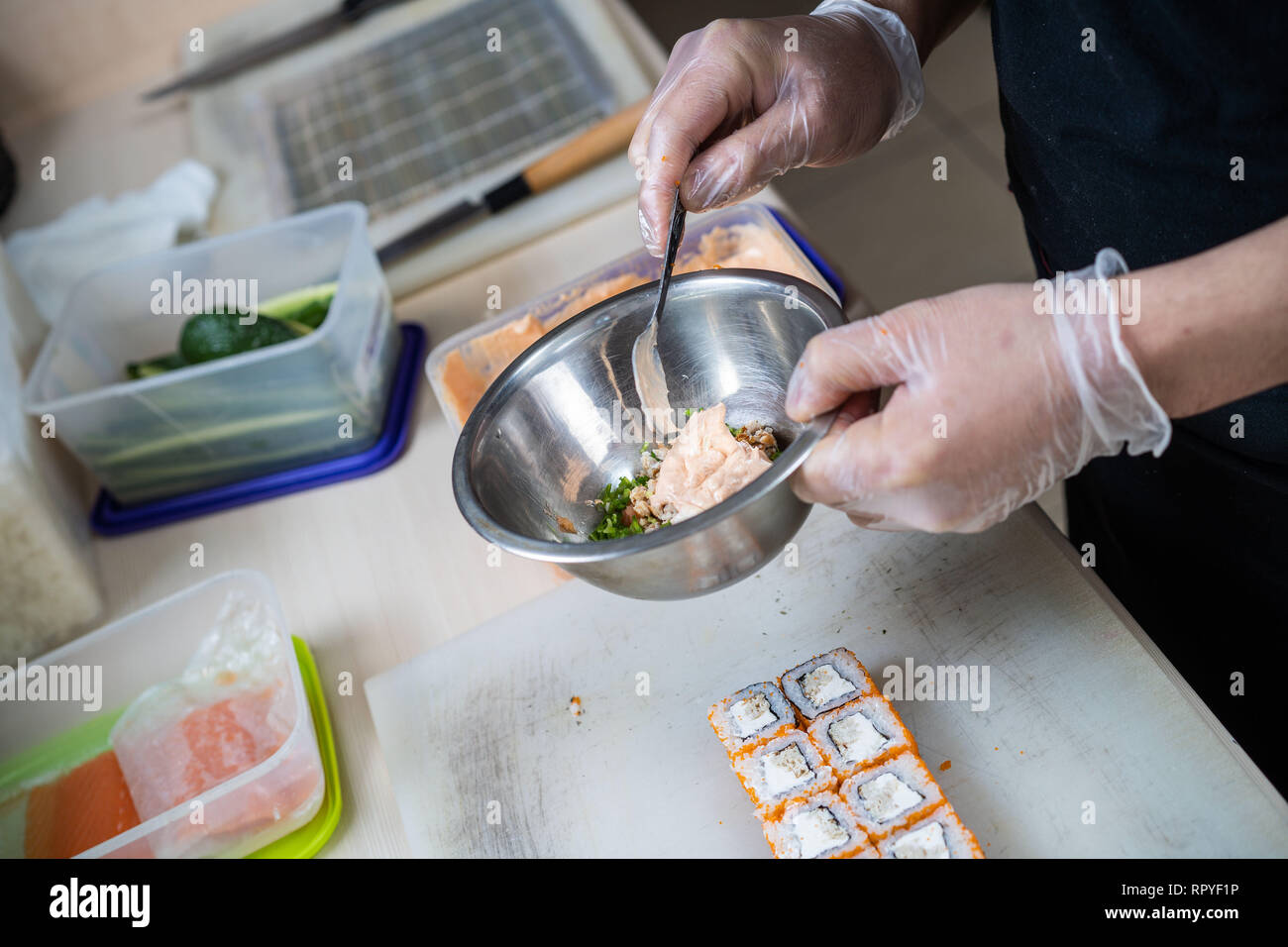 Cook hands making japanese sushi roll. Japanese chef at work preparing ...