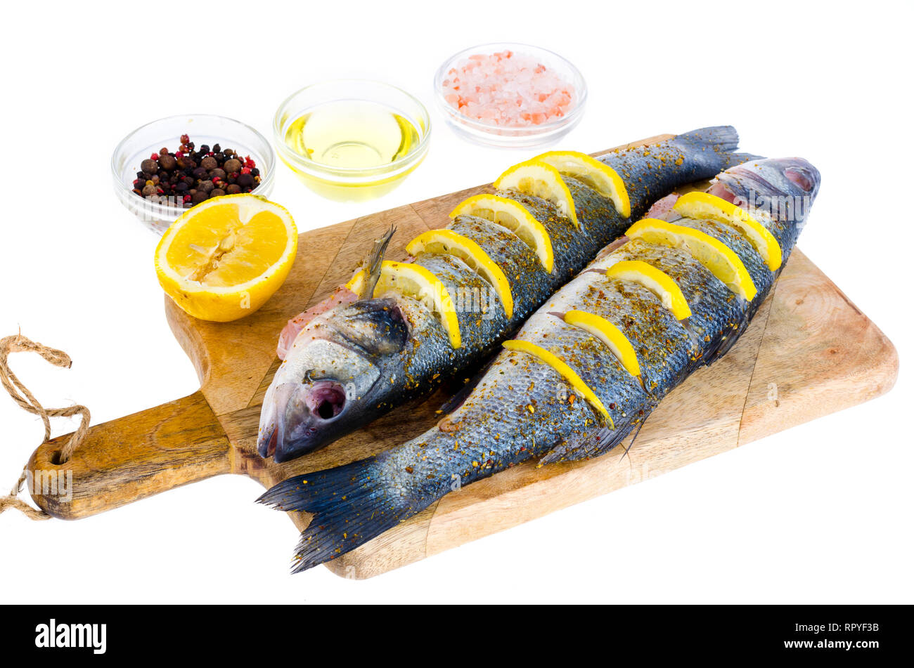 Dicentrarchus labrax fish with lemon for cooking. Studio Photo Stock ...