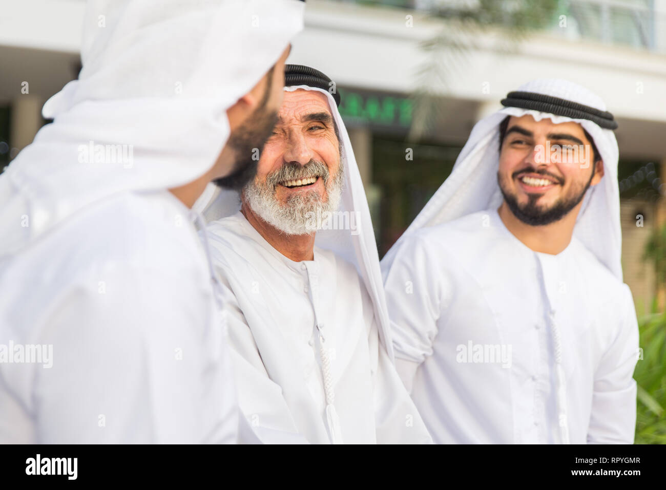 Group of arabian businessmen with kandura meeting outdoors in UAE ...