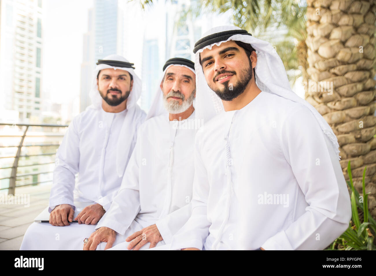 Group of arabian businessmen with kandura meeting outdoors in UAE ...