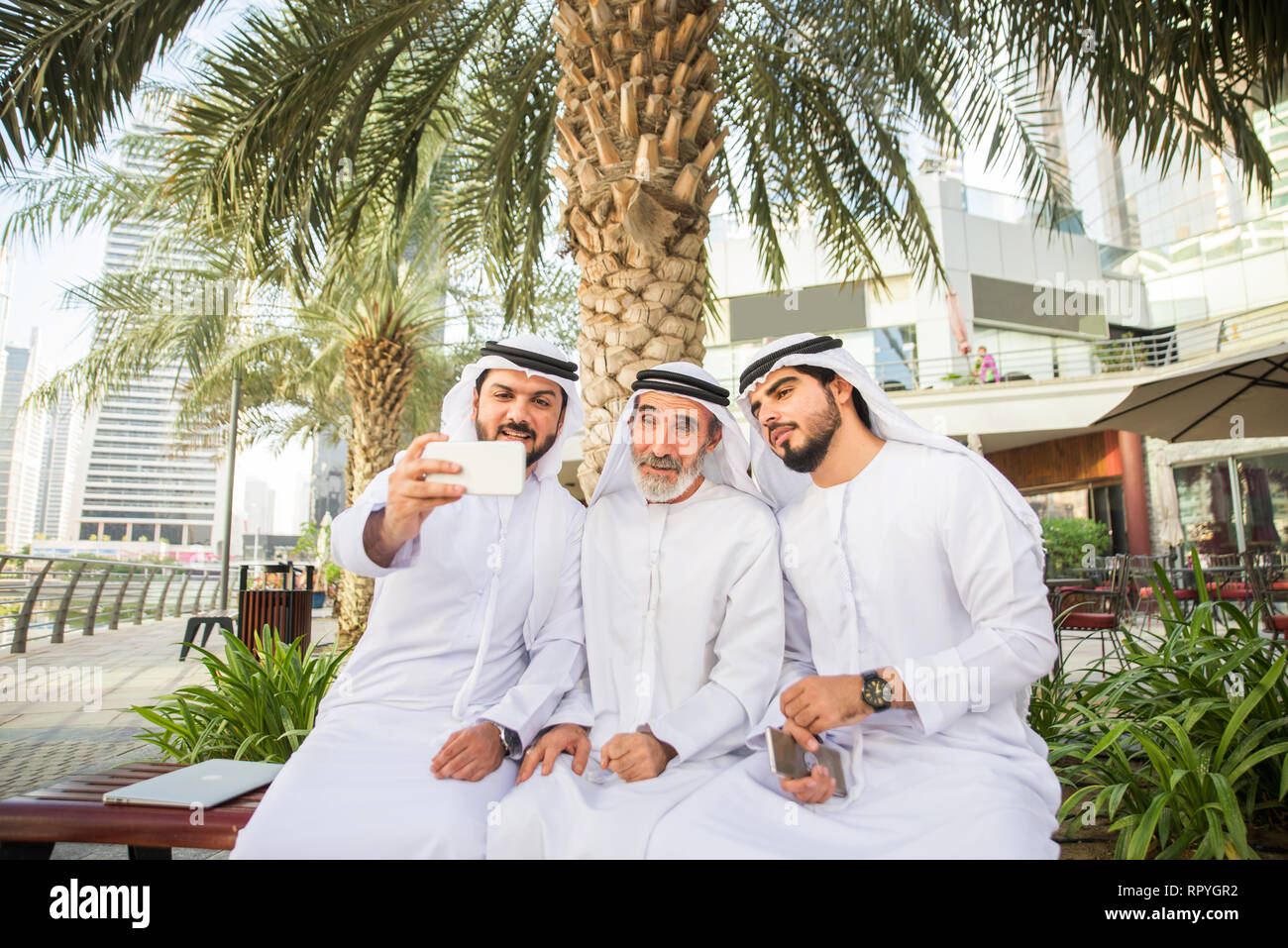 Group of arabian businessmen with kandura meeting outdoors in UAE ...