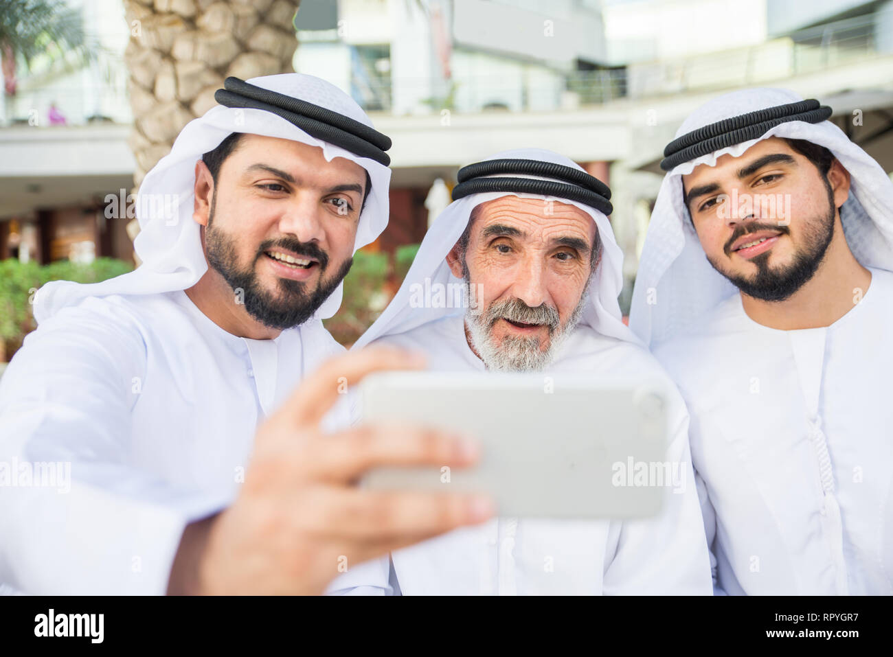 Group of arabian businessmen with kandura meeting outdoors in UAE ...