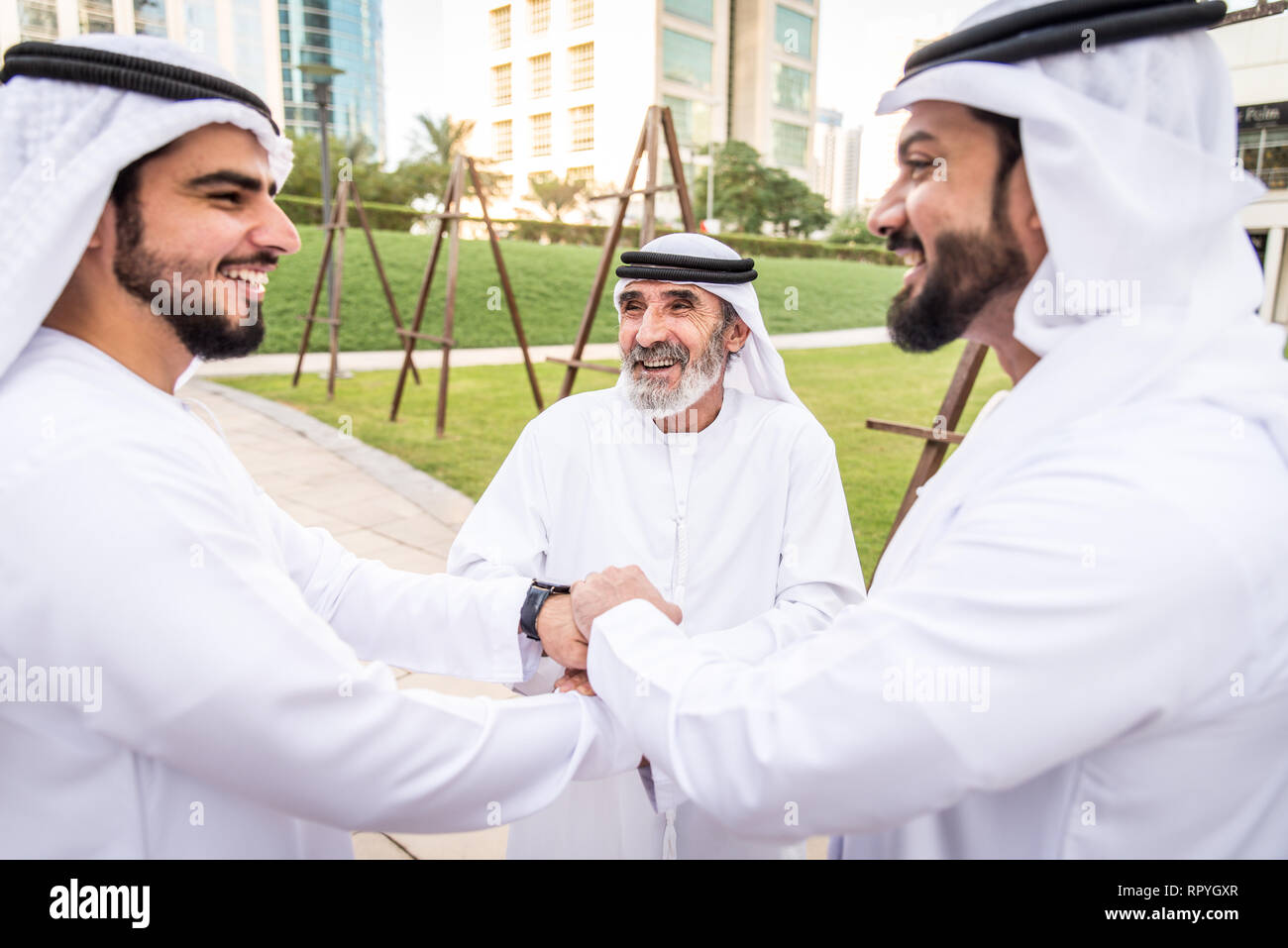Group of arabian businessmen with kandura meeting outdoors in UAE ...