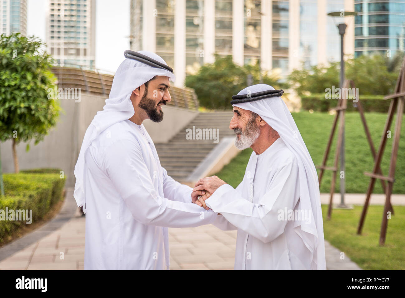 Group of arabian businessmen with kandura meeting outdoors in UAE ...
