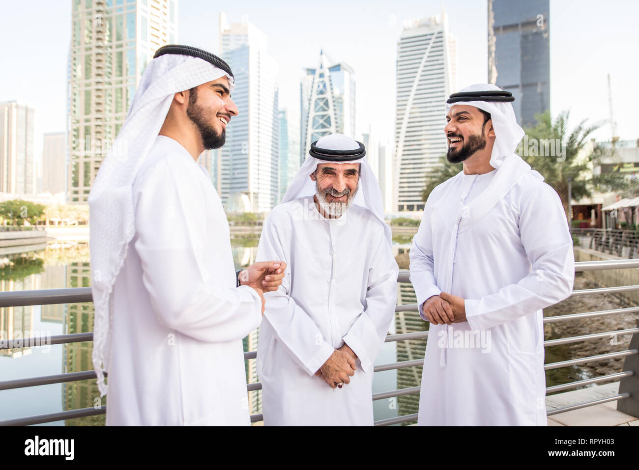Group of arabian businessmen with kandura meeting outdoors in UAE ...
