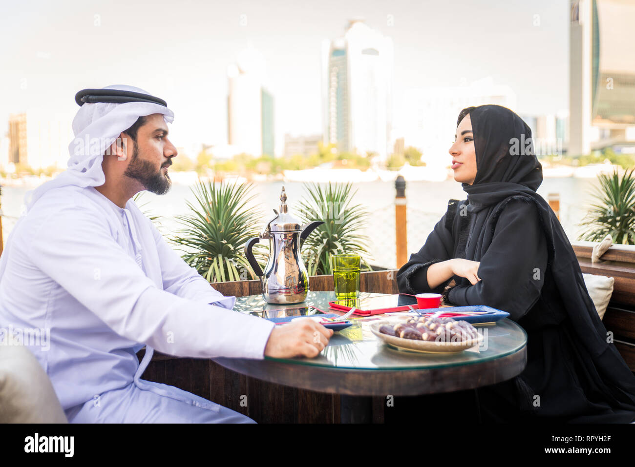 Arabian couple with traditional emirates dress dating outdoors - Happy ...