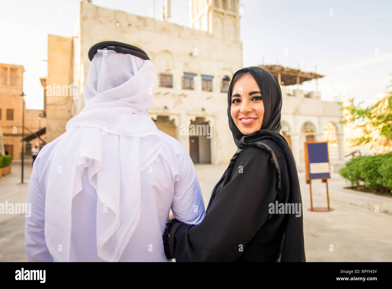Arabian couple with traditional emirates dress dating outdoors - Happy ...