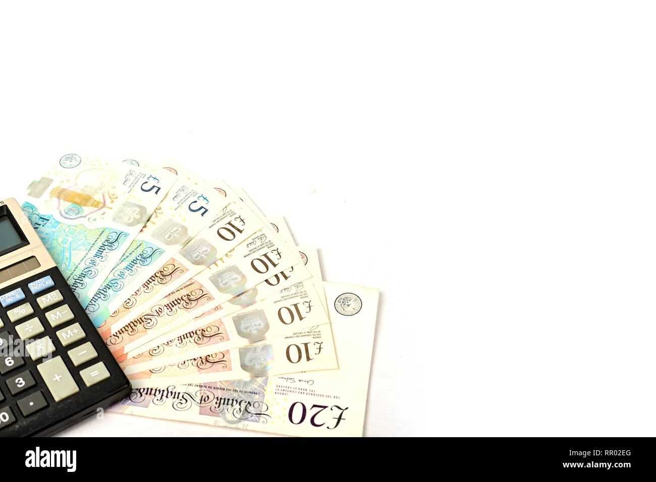 Counting British pound isolated by calculator on white background Stock ...