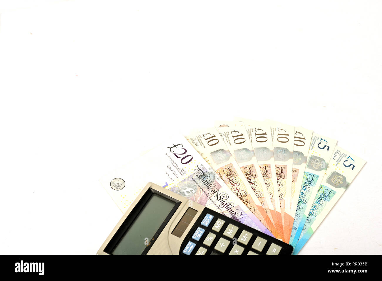 Counting British pound isolated by calculator on white background Stock ...