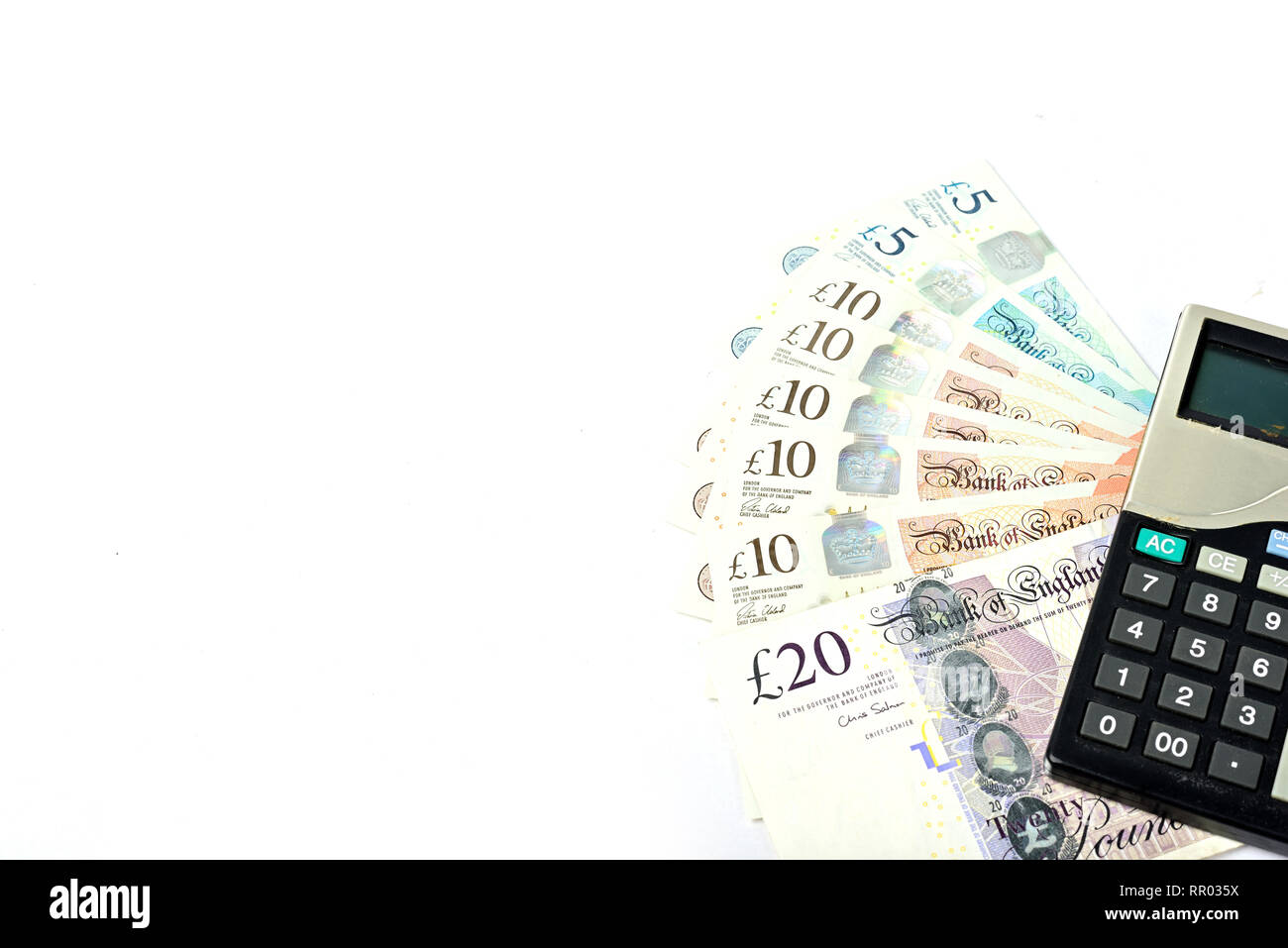 Counting British pound isolated by calculator on white background Stock ...