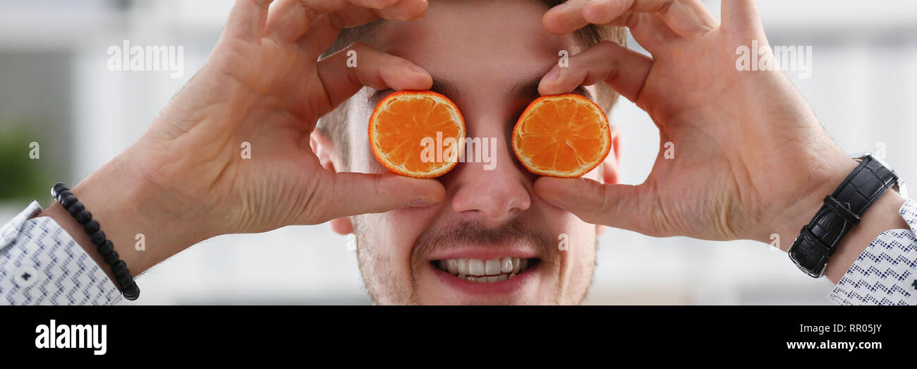 Male hands hold a cut fruit at eye level Stock Photo - Alamy