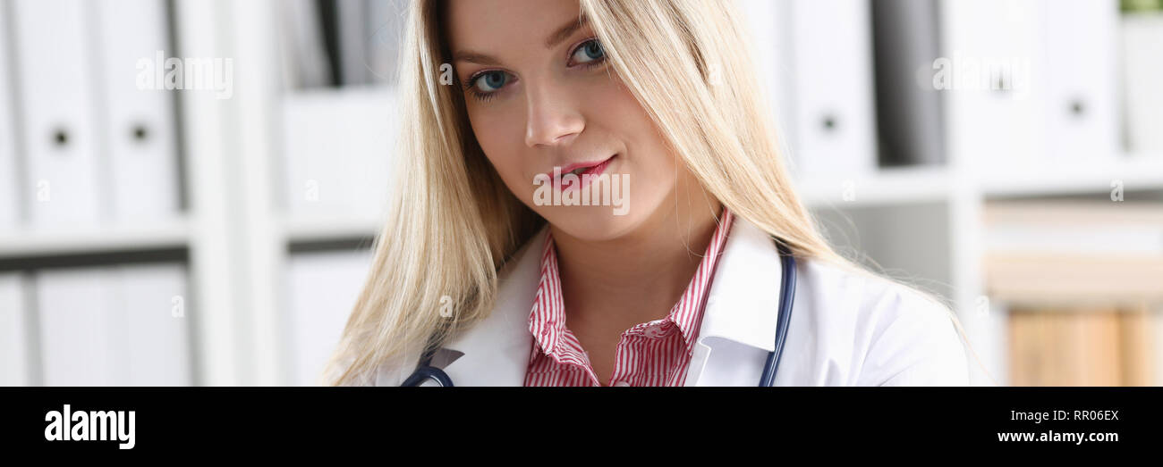 Beautiful smiling female doctor sit at workplace Stock Photo - Alamy