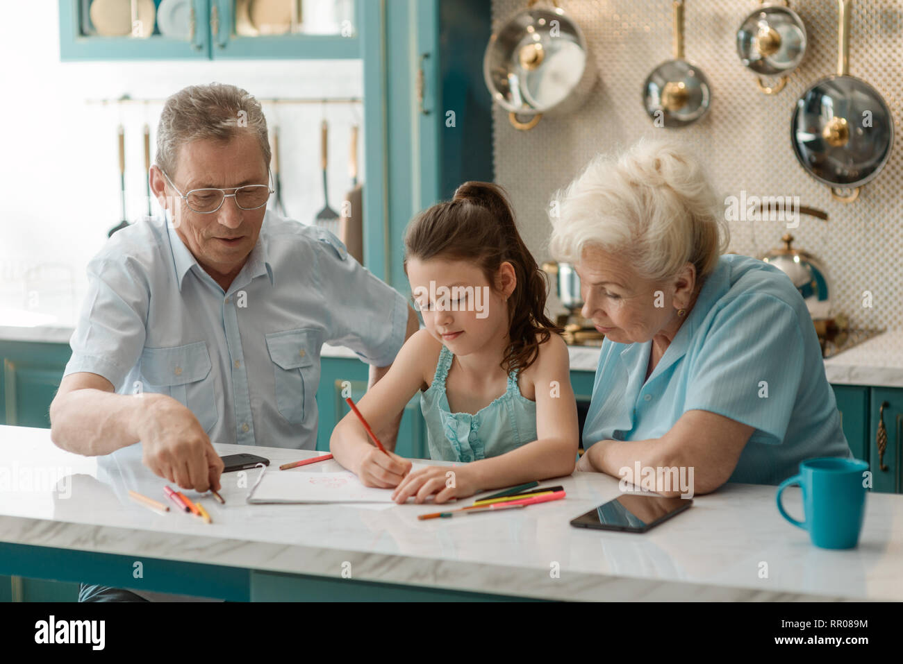 Grandparents teach a kid Stock Photo - Alamy