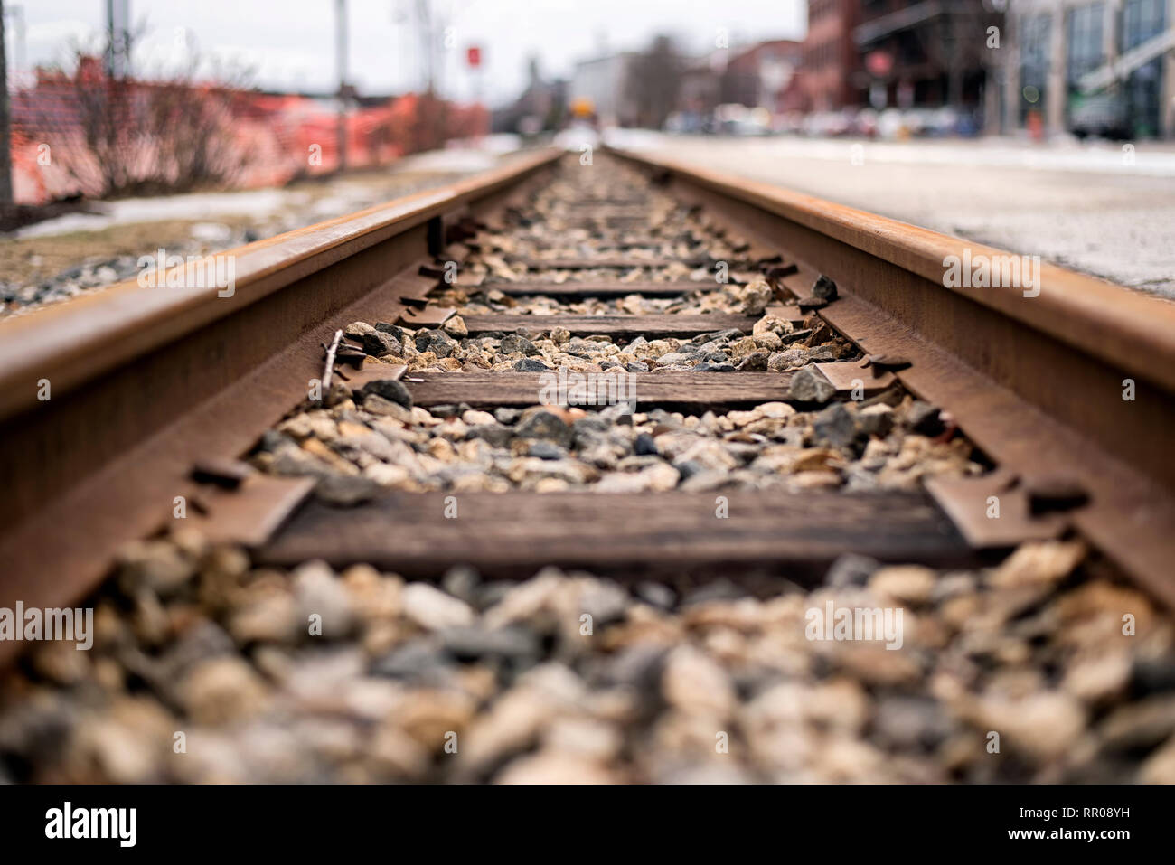 A set of railroad tracks running parallel to a street in Portland Maine ...