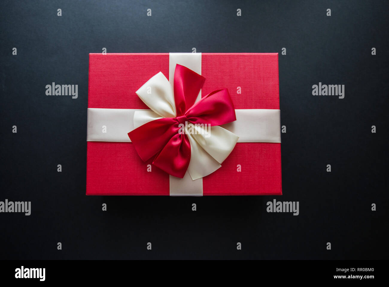 Real box with white and red bow and ribbon top view on holiday isolated ...